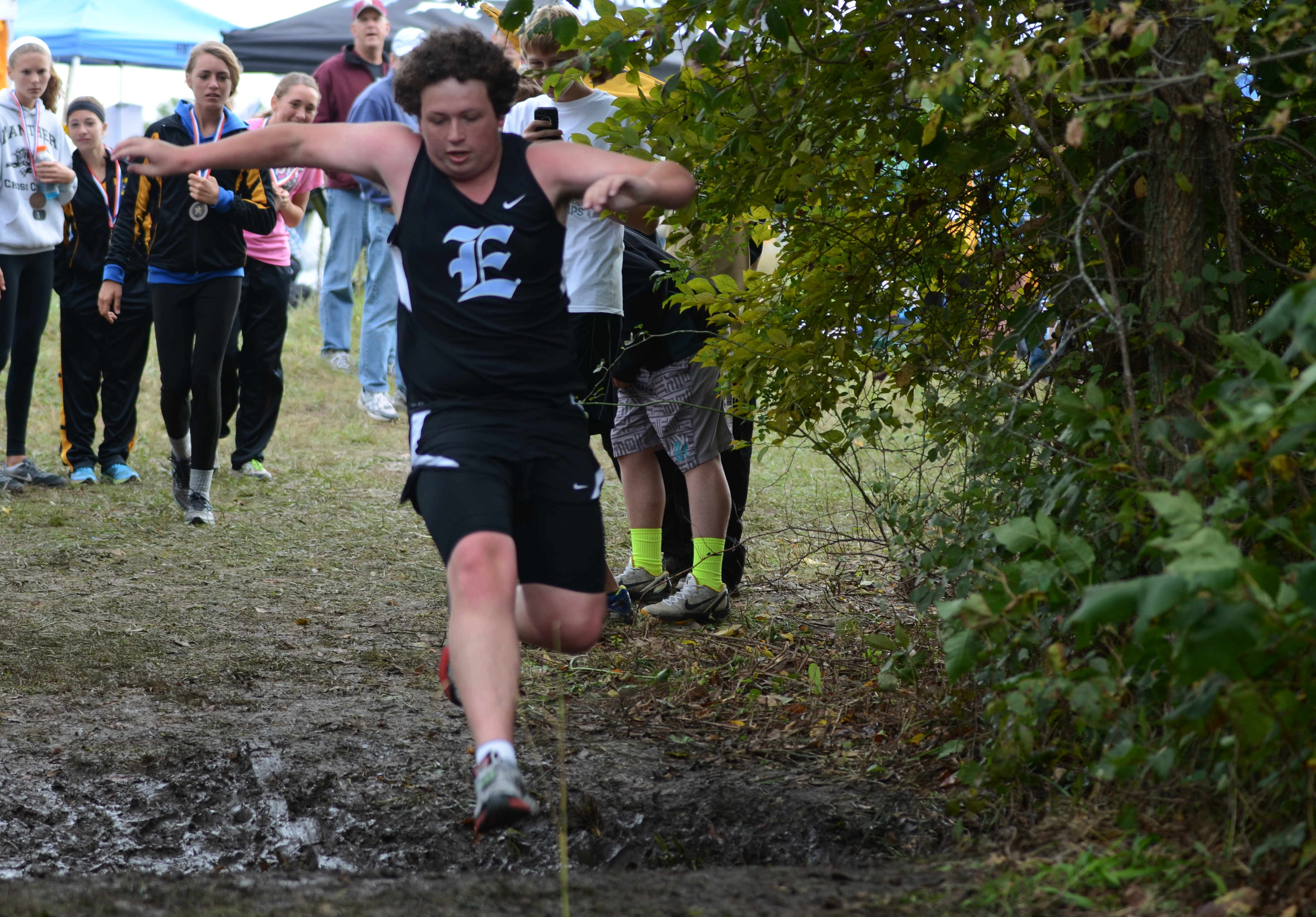Junior Truman Peters jumps over a large gap during the run. Photo by ...