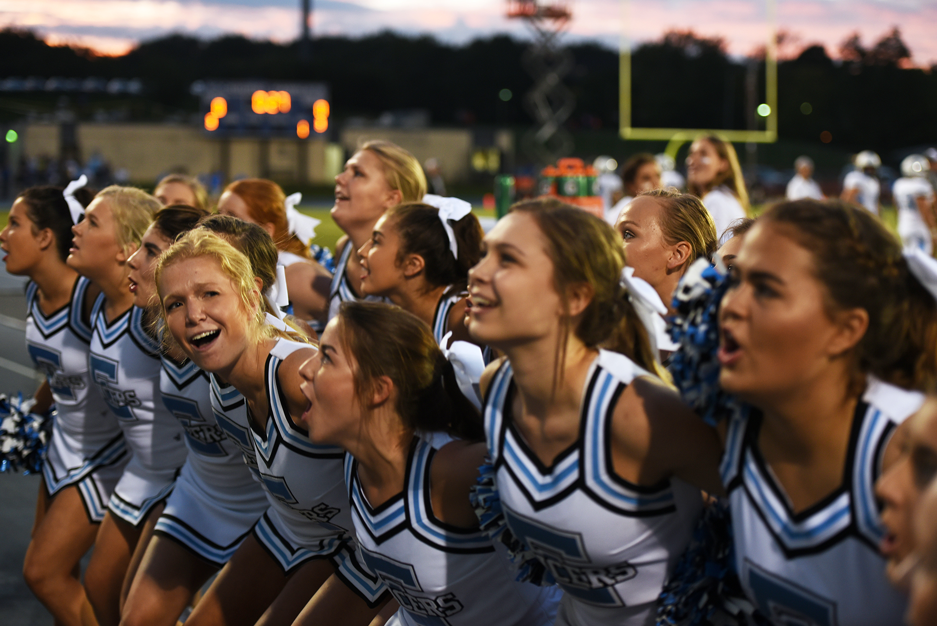 Senior Hope Hess laughs while varsity cheer chants in the beginning of ...