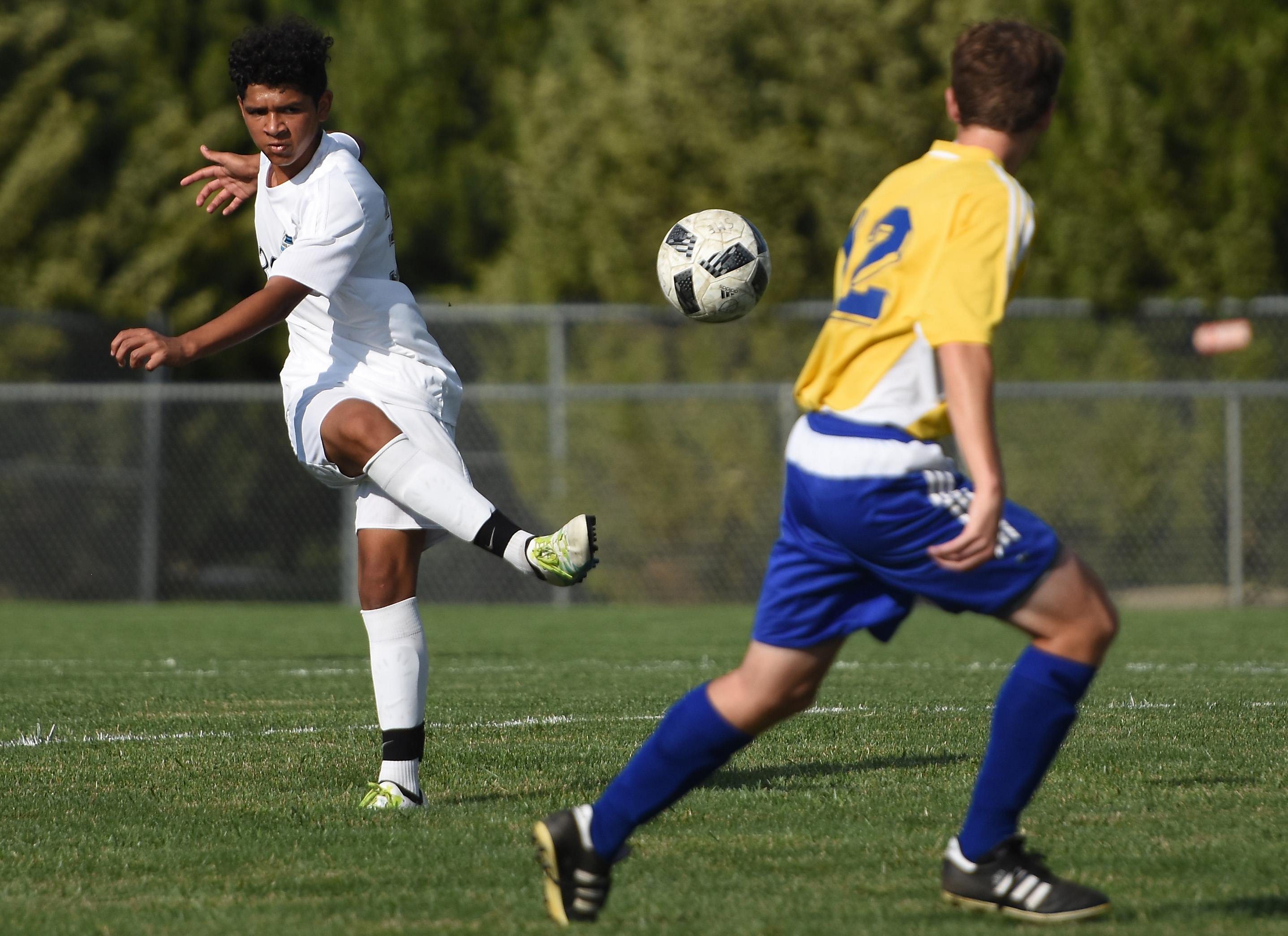 Freshman Sean Brookes passes the ball down the field to a teammate ...