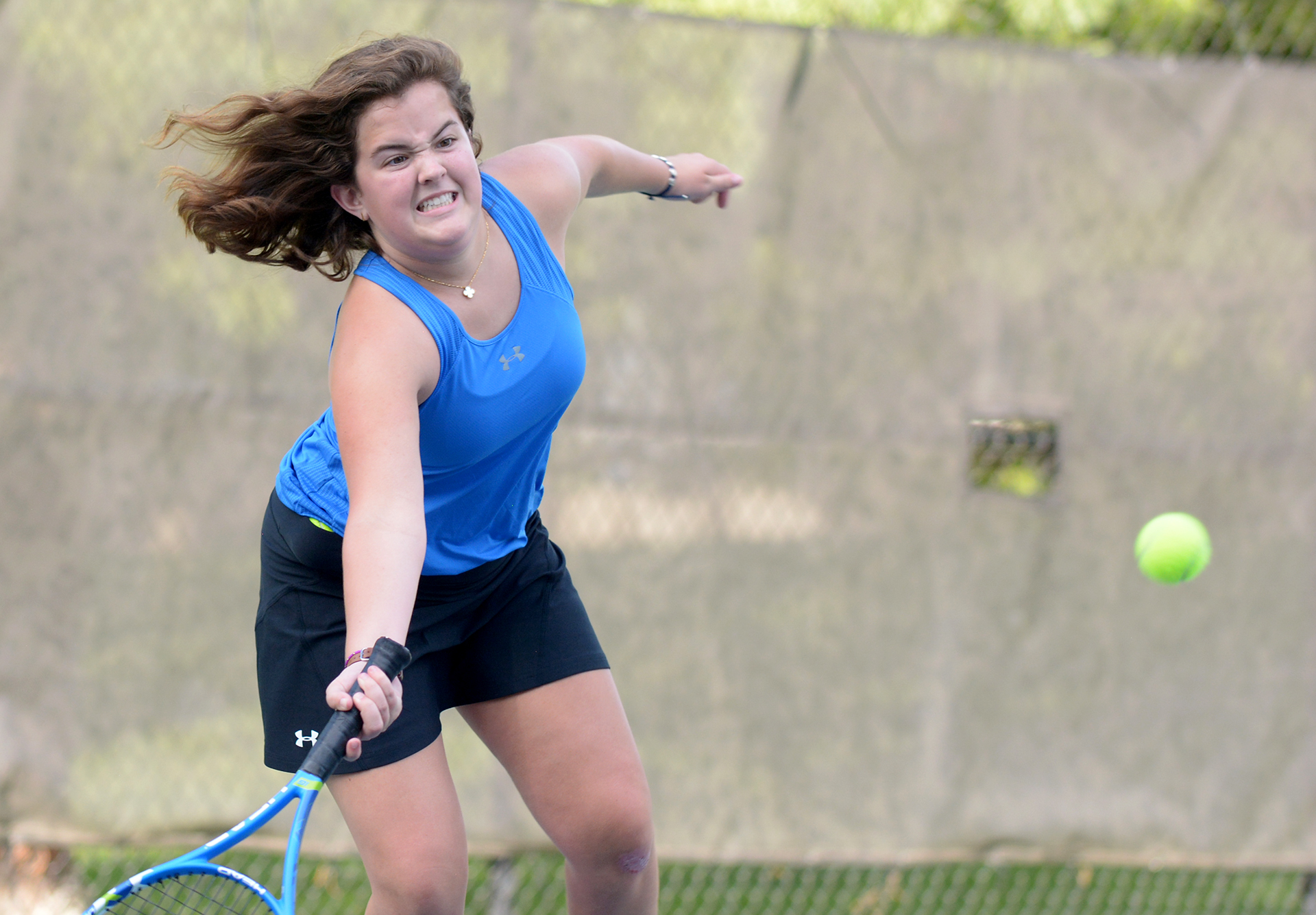 Junior Riley Moreland dives for a forehand shot during a singles match ...