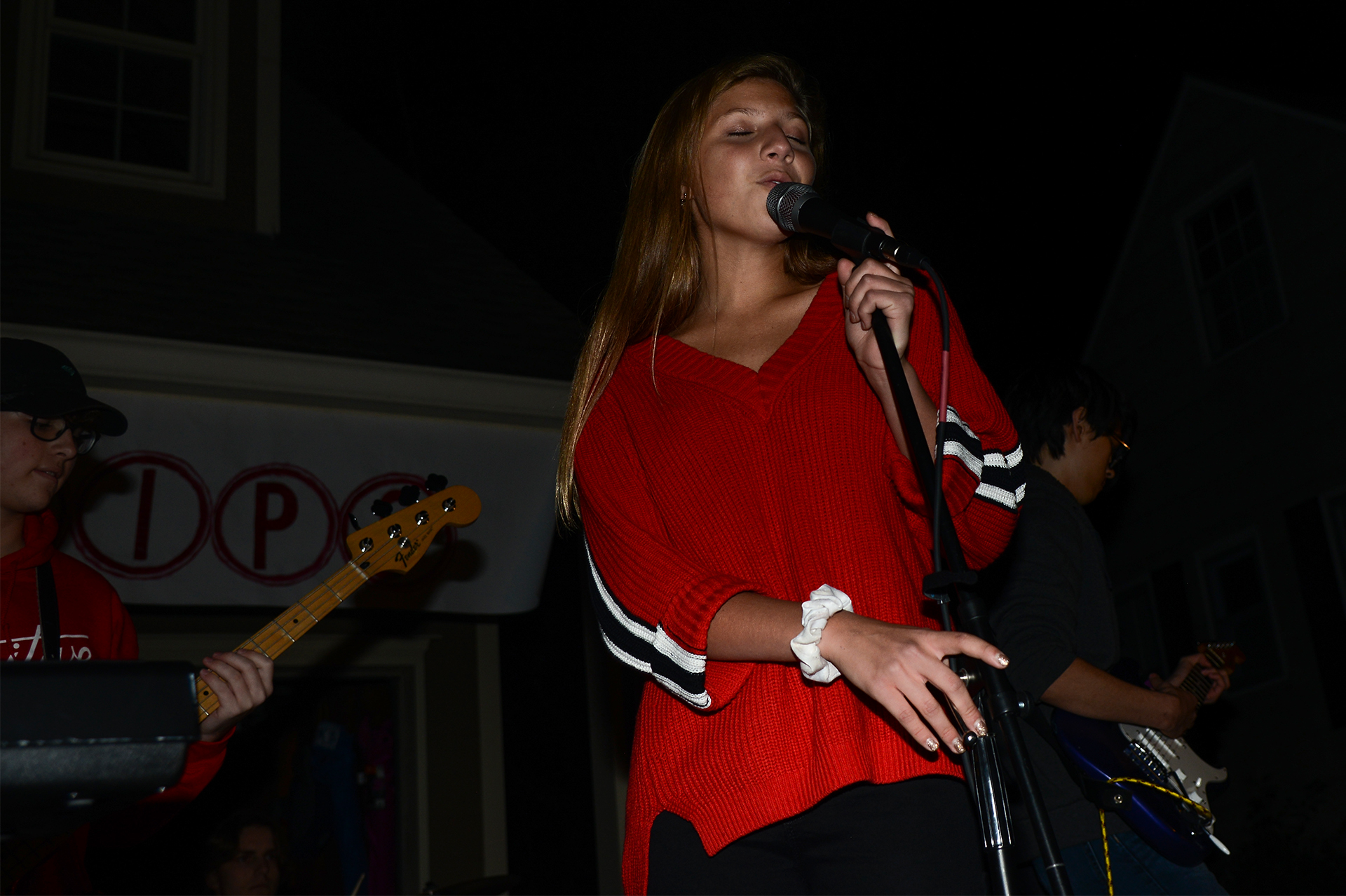 Sophomore Anna McQueeny sings during “Redbone”, her main solo. Photo by ...
