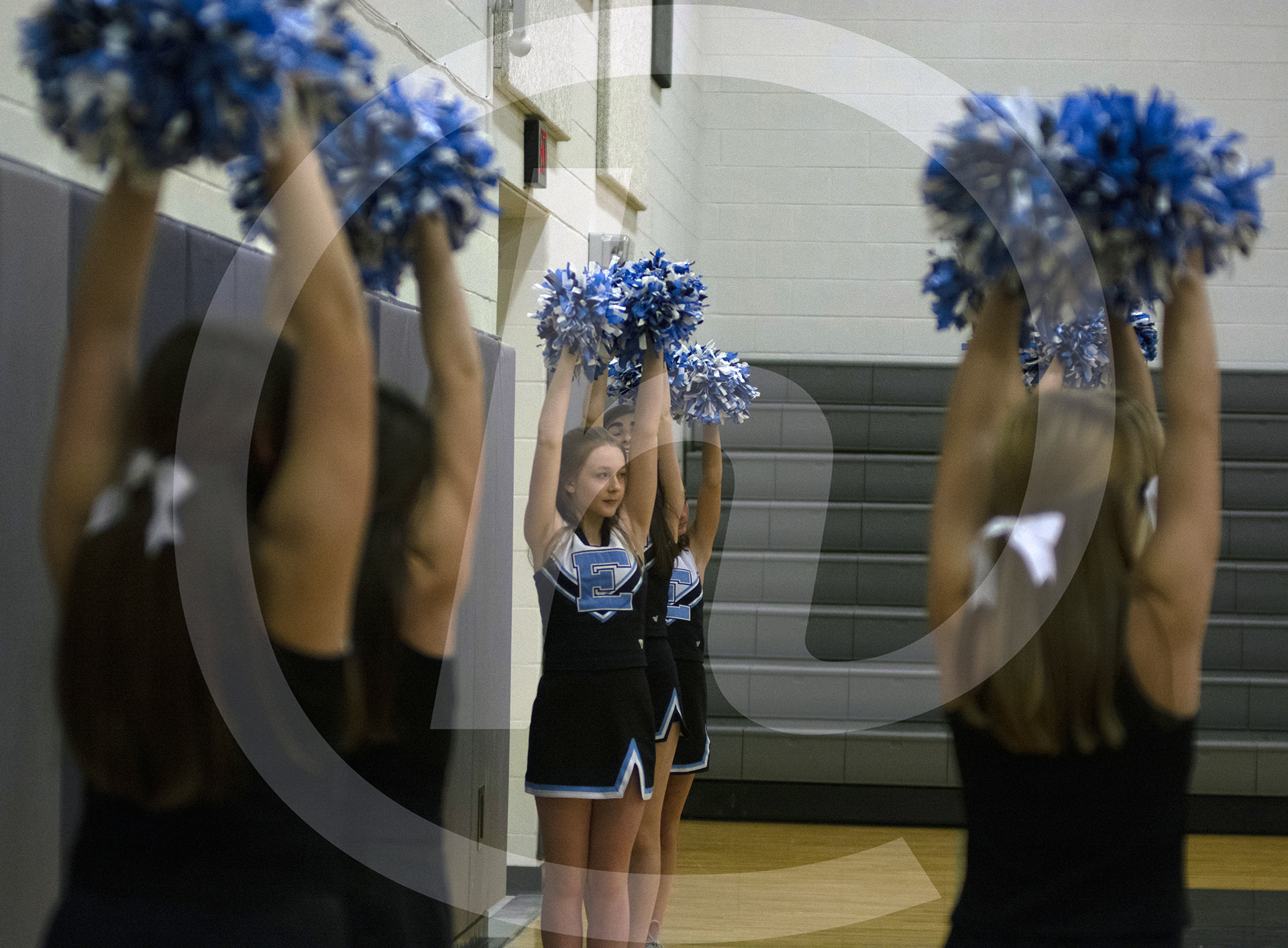 Freshman Emmy Patterson holds up her pom poms during a cheer routine ...