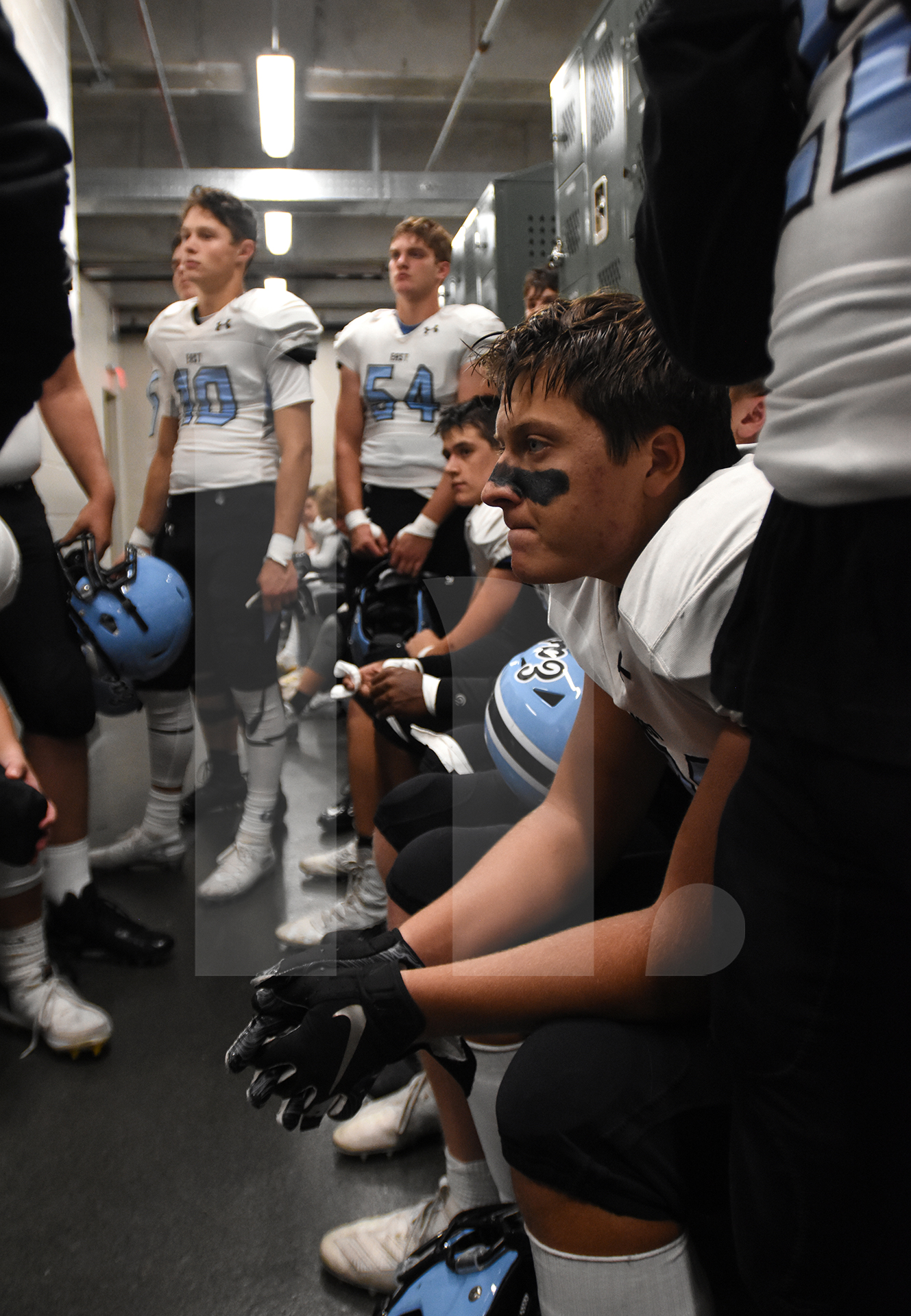 Senior Sam Scholte rests in the locker room and listens to coach Long ...